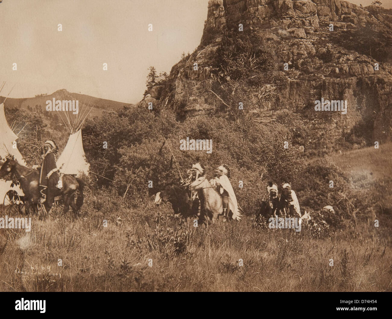 This image depicts Native Americans on horseback, capturing a moment of ...