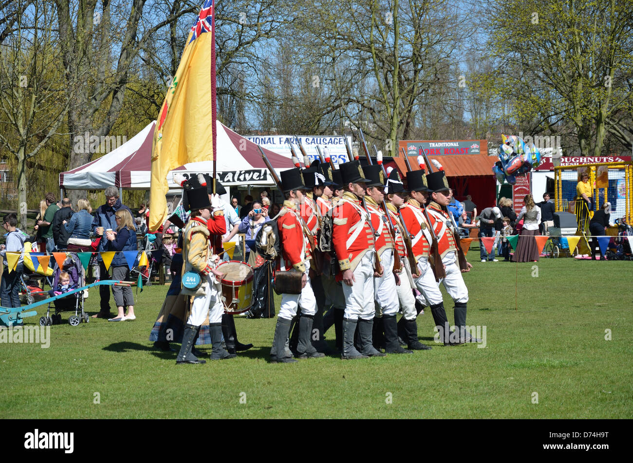Redcoat soldiers marching near to camera in reenactment from side Stock ...