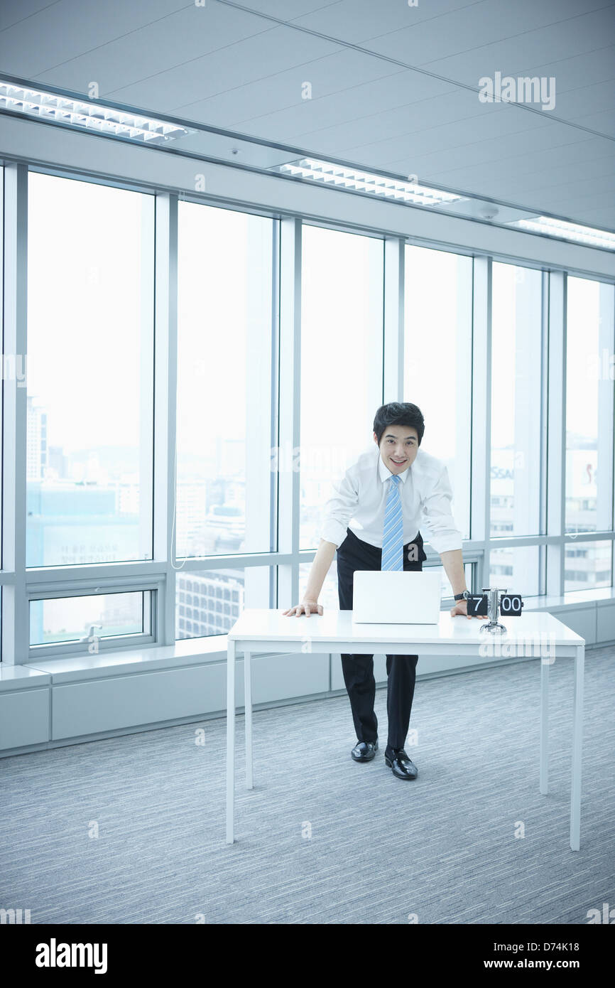 a businessman with a desk in an empty office Stock Photo - Alamy