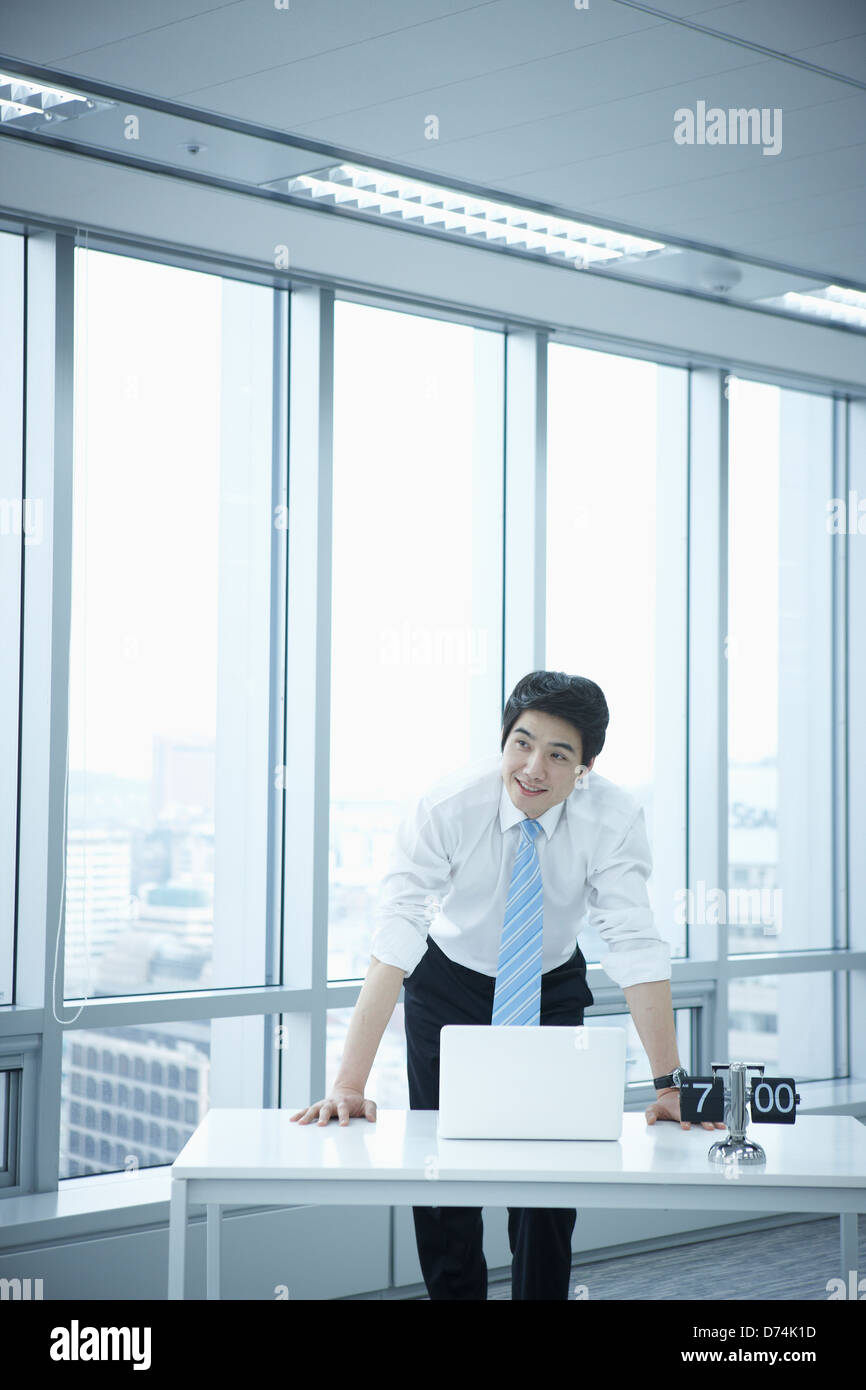 a businessman with a desk in an empty office Stock Photo - Alamy