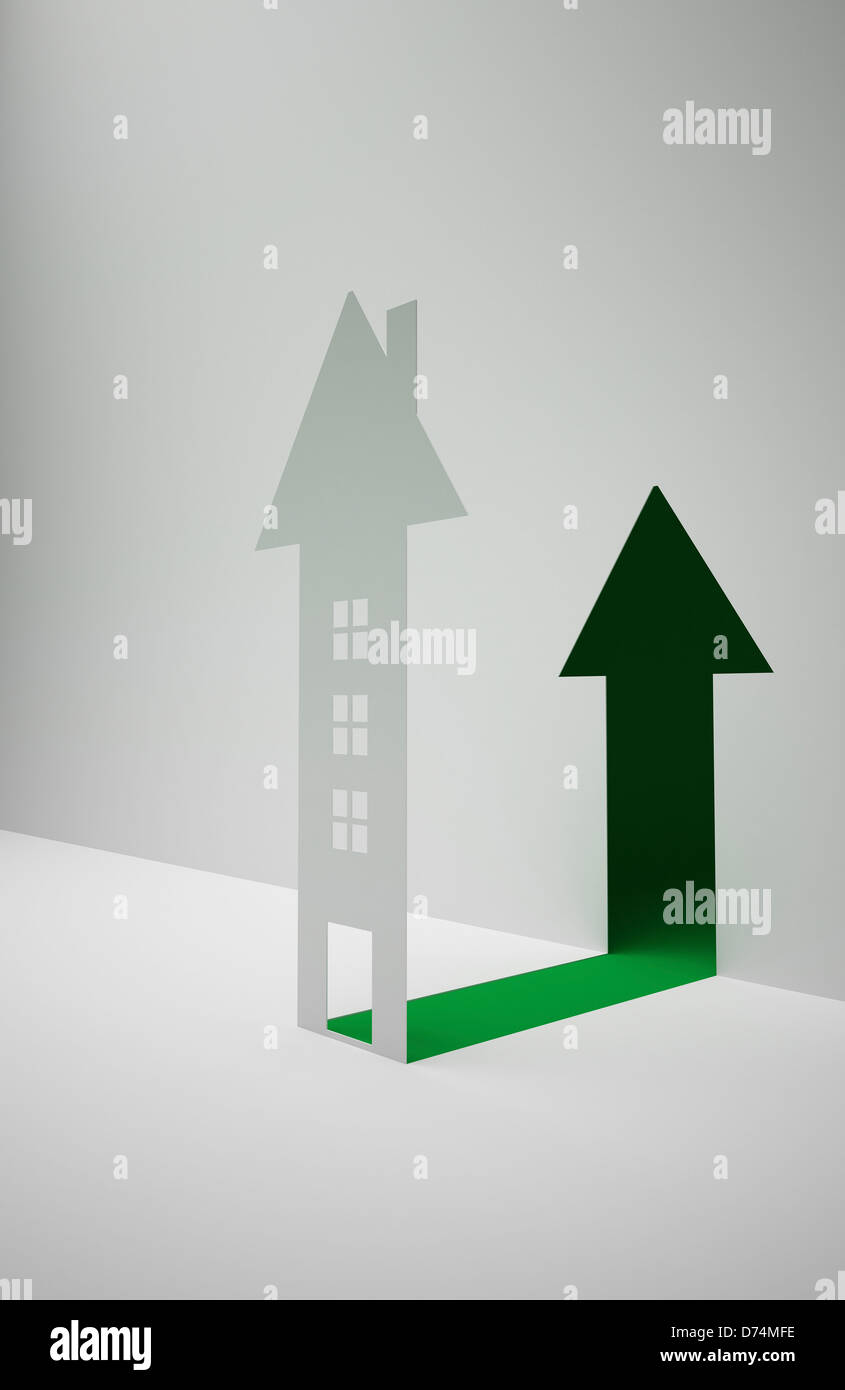 a green arrow as a shadow of a house Stock Photo - Alamy