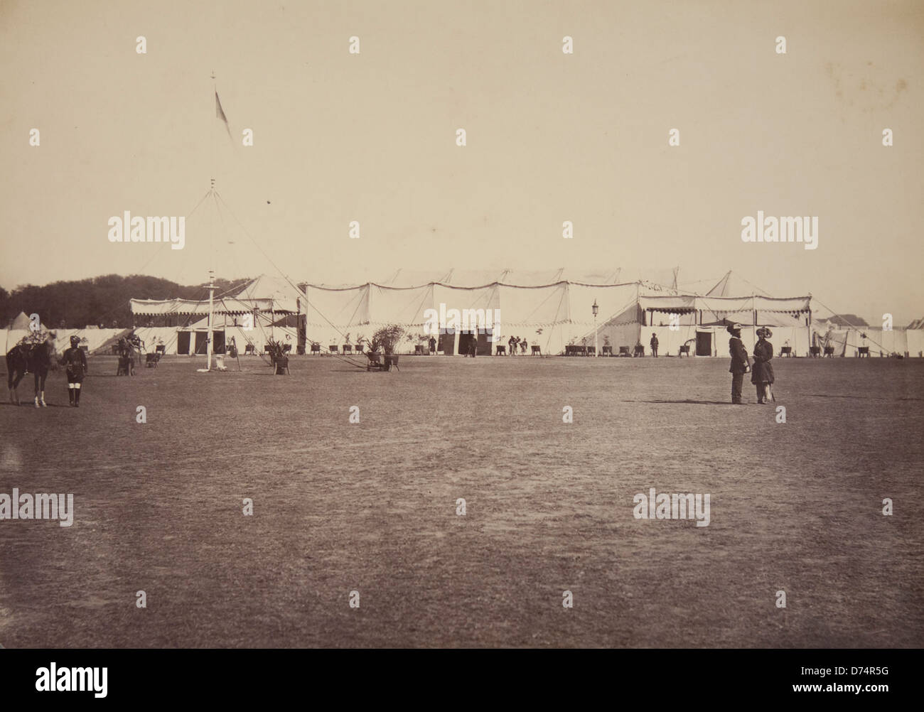 This photograph depicts a military camp scene with tents, illustrating ...