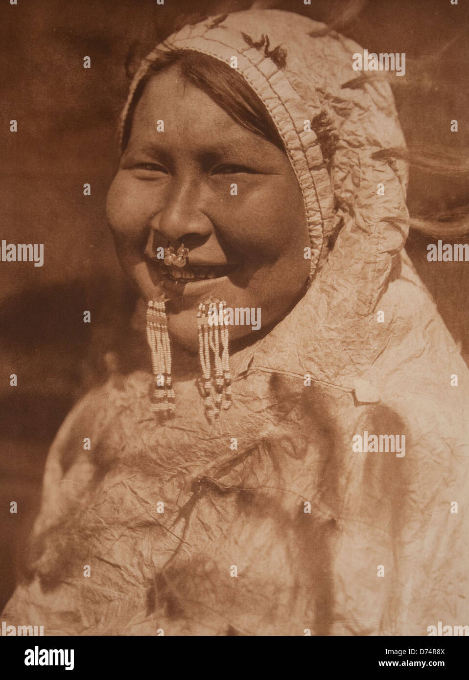 This image depicts Ugiyaki, wearing a beaded cap, from the Nunivak ...