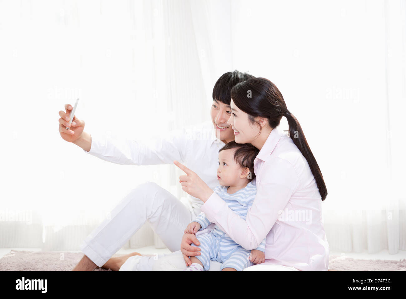 parents taking photo with baby Stock Photo - Alamy