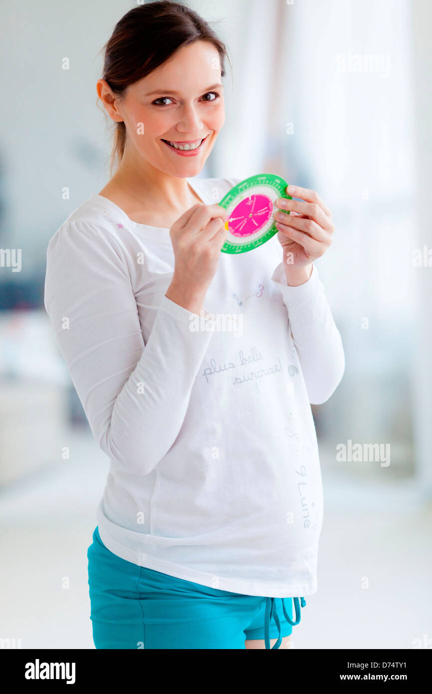 Woman using a conception chart to determine the term of pregnancy Stock ...