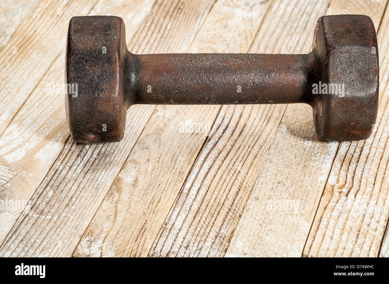vintage iron rusty dumbbells on weathered white painted barn wood ...