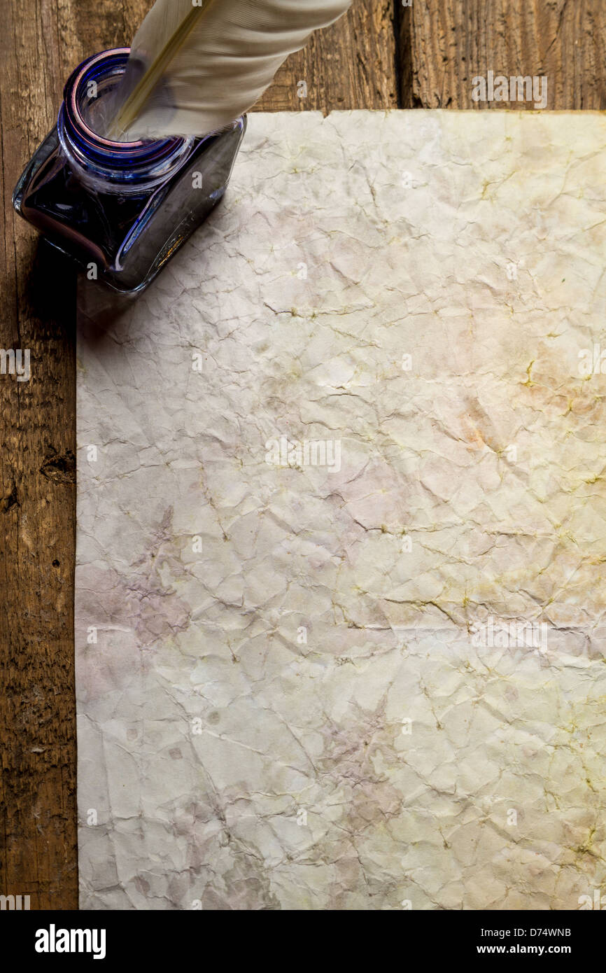 Old damaged sheet of paper with inkwells Stock Photo - Alamy