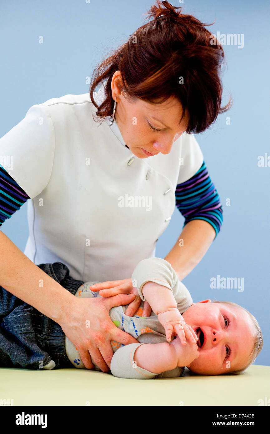 Physical Therapist performing respiratory physiotherapy on baby Stock ...