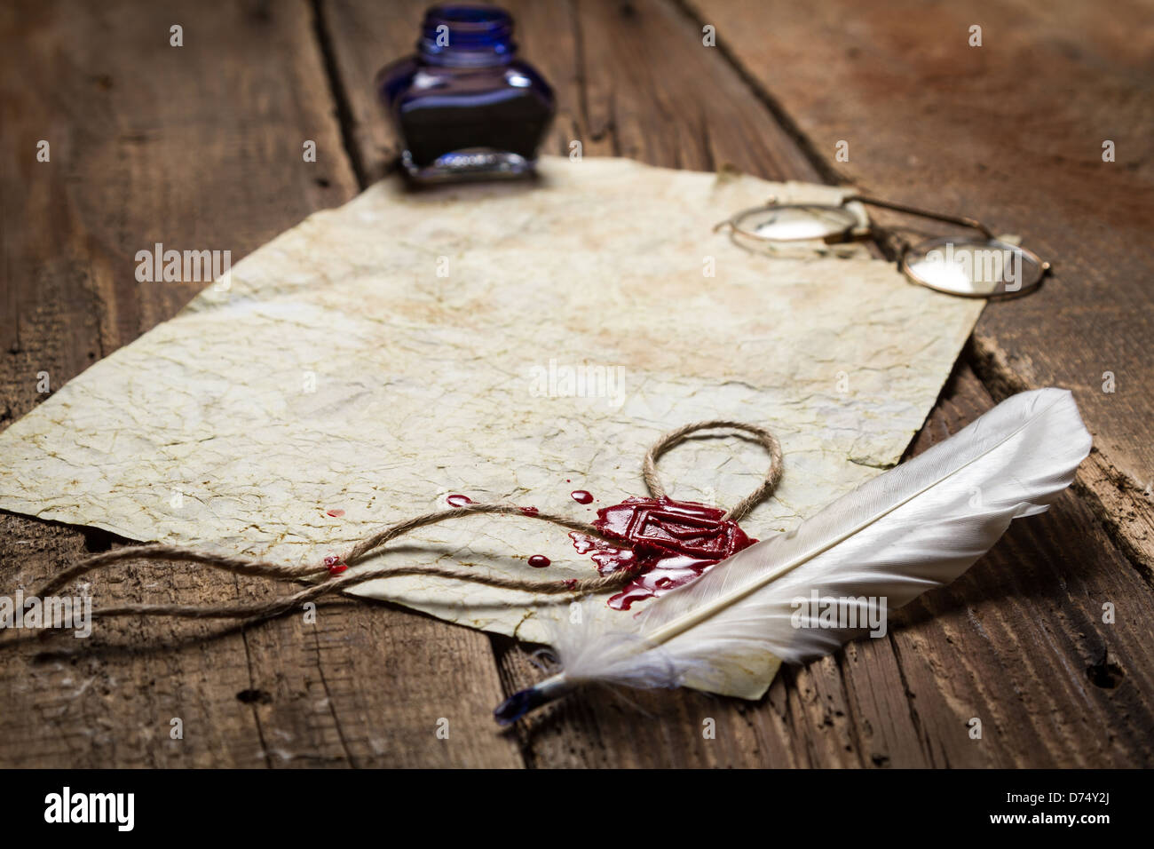 Feather and red sealing wax on old vintage paper Stock Photo - Alamy