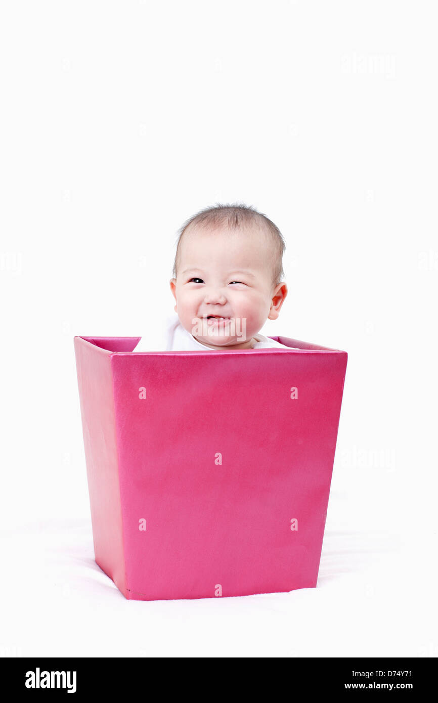 a baby inside a pink gift box Stock Photo - Alamy