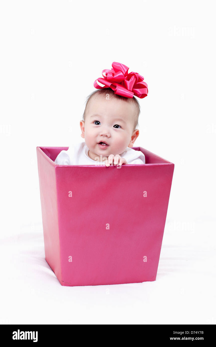 a baby inside a pink gift box Stock Photo - Alamy