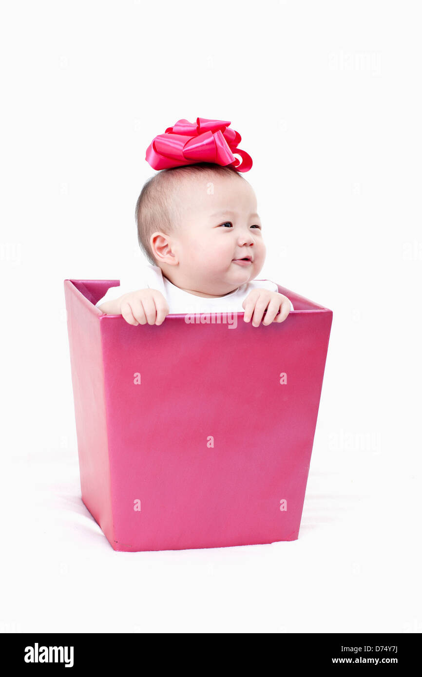 a baby inside a pink gift box Stock Photo - Alamy