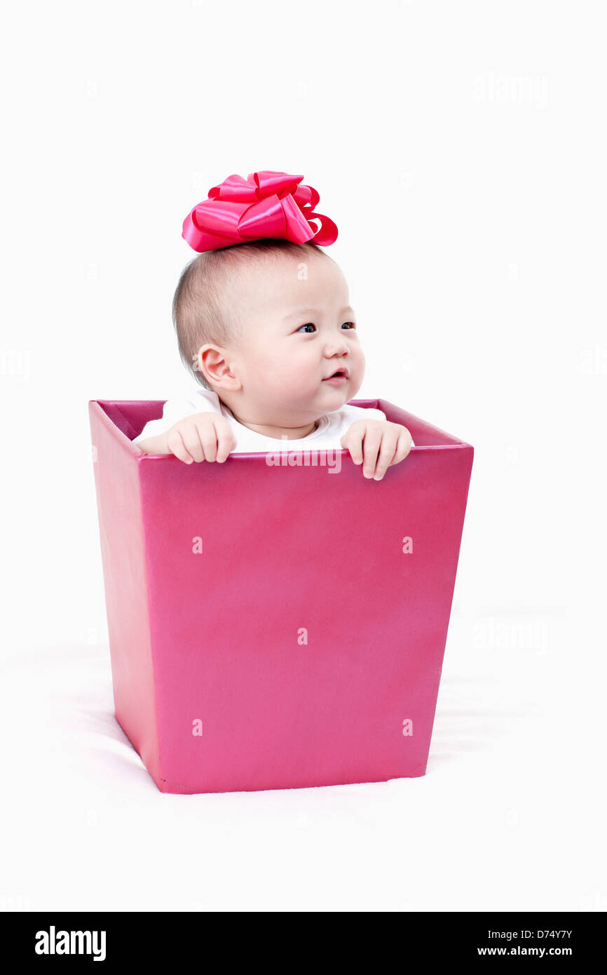 a baby inside a pink gift box Stock Photo - Alamy