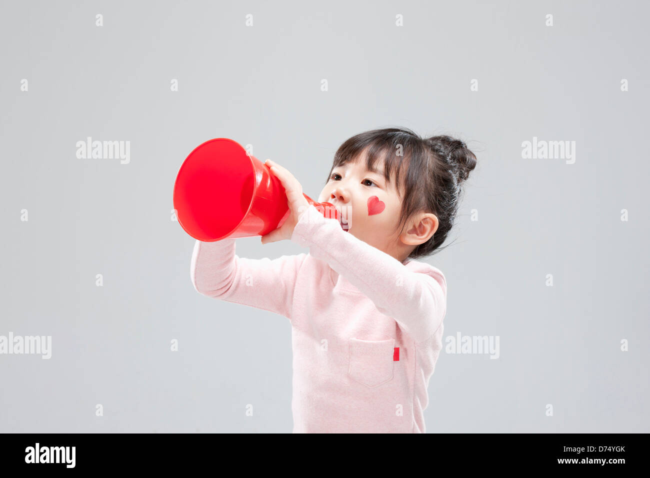 a girl shouting on red megaphone Stock Photo - Alamy