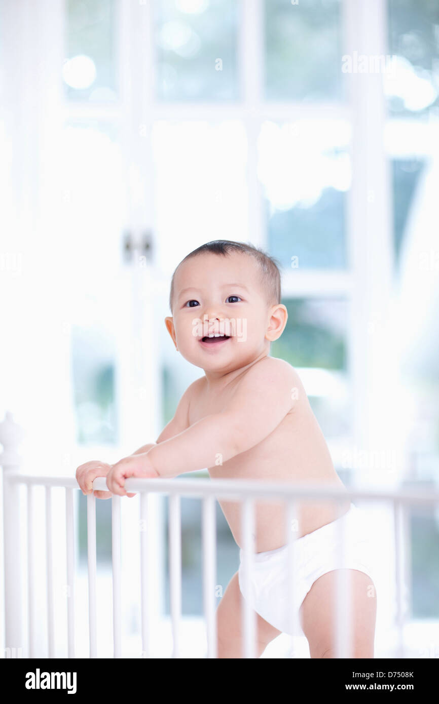 a baby inside a crib Stock Photo - Alamy
