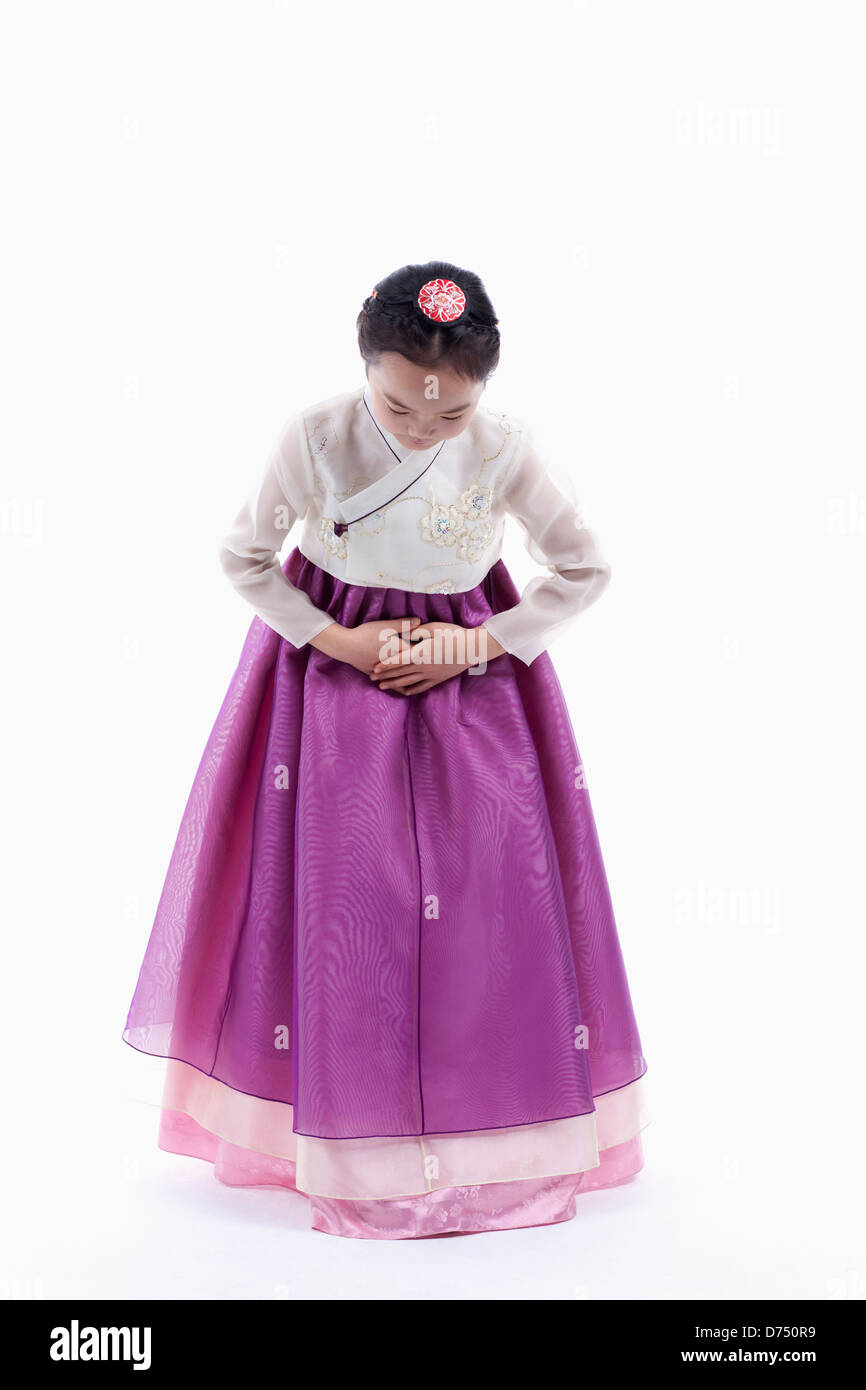 a girl in Korean traditional costume bowing Stock Photo - Alamy