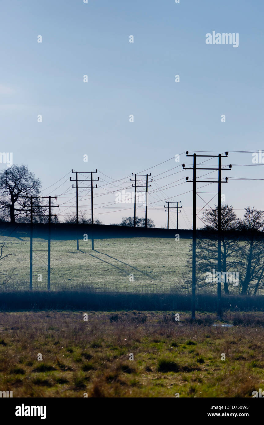 power lines over farm field Stock Photo - Alamy