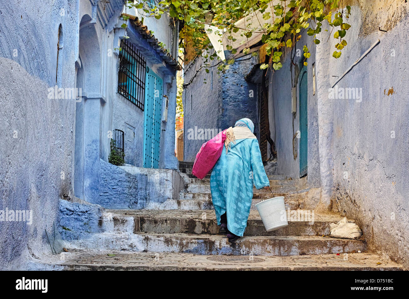 Woman on stairs in Chefchaouen Stock Photo - Alamy