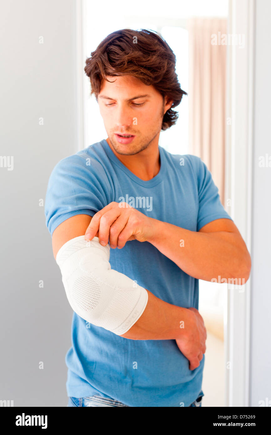 Man wearing a elbow holder Stock Photo - Alamy