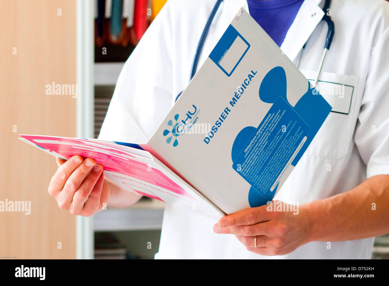 Doctor reading medical records in a hospital Stock Photo - Alamy
