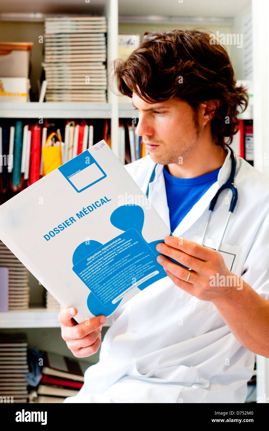Doctor reading medical records in a hospital Stock Photo - Alamy