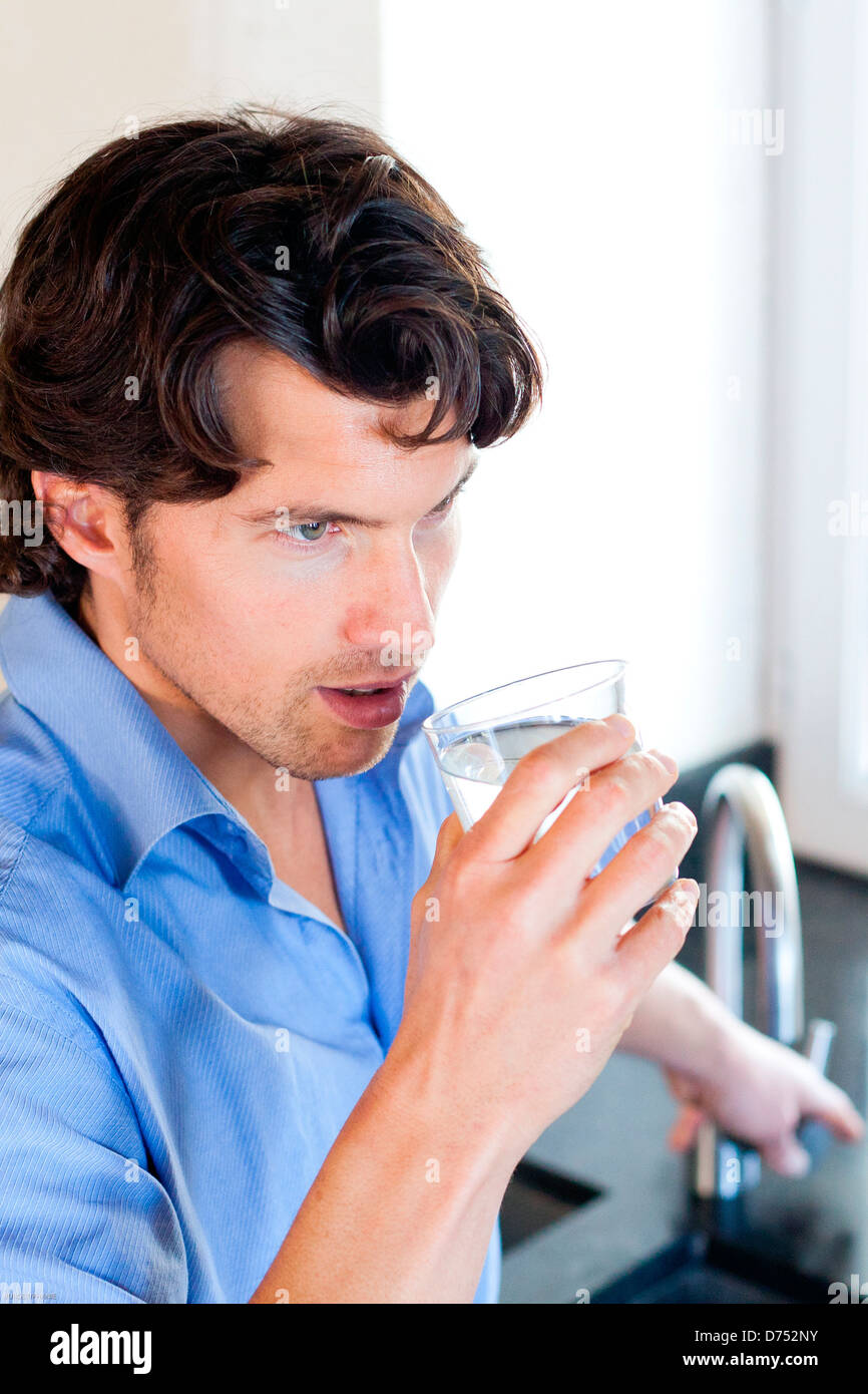 Man drinking glass of water Stock Photo - Alamy
