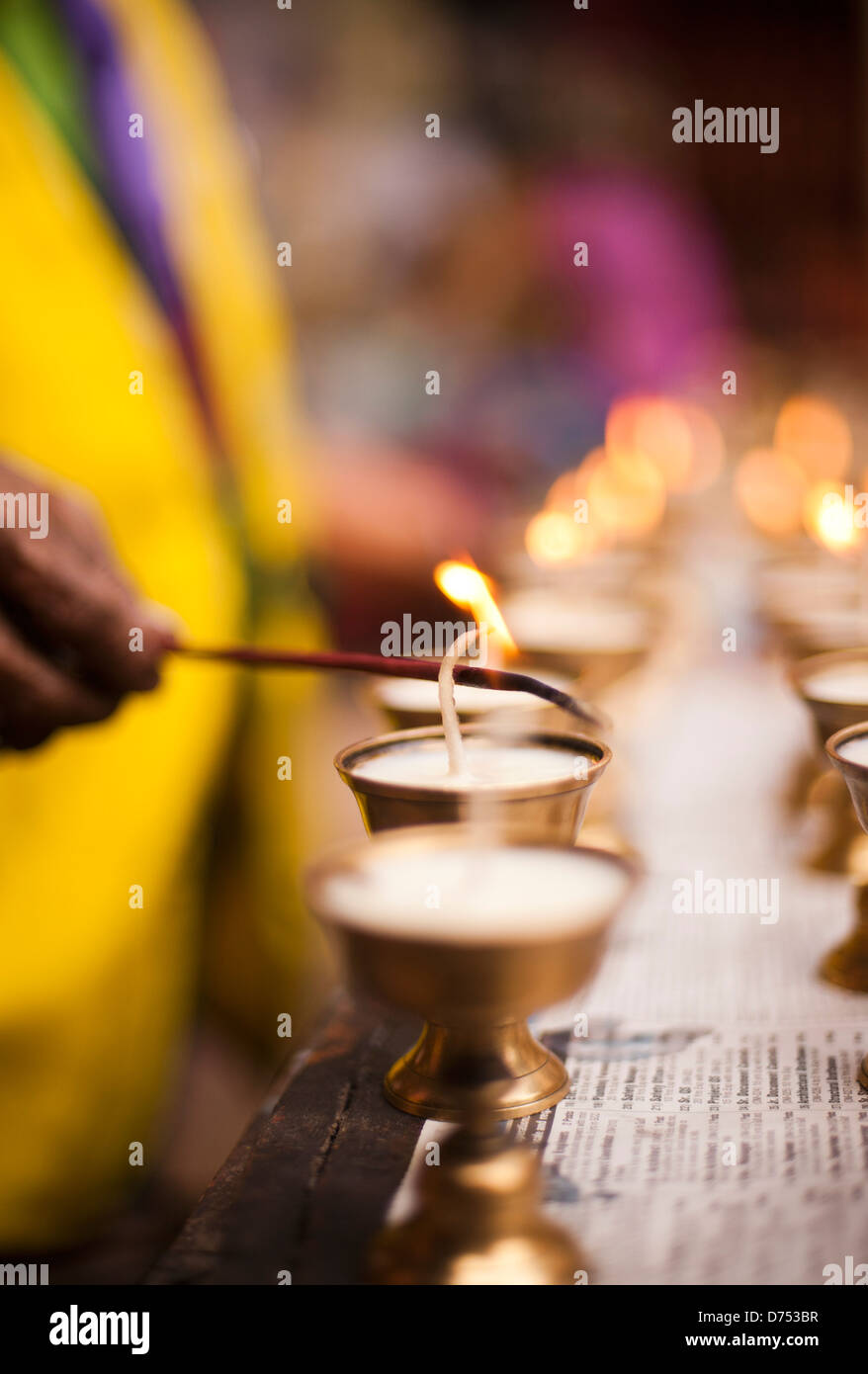 Person lighting candles in a monastery, Tibetan Monastery, Delhi, India ...