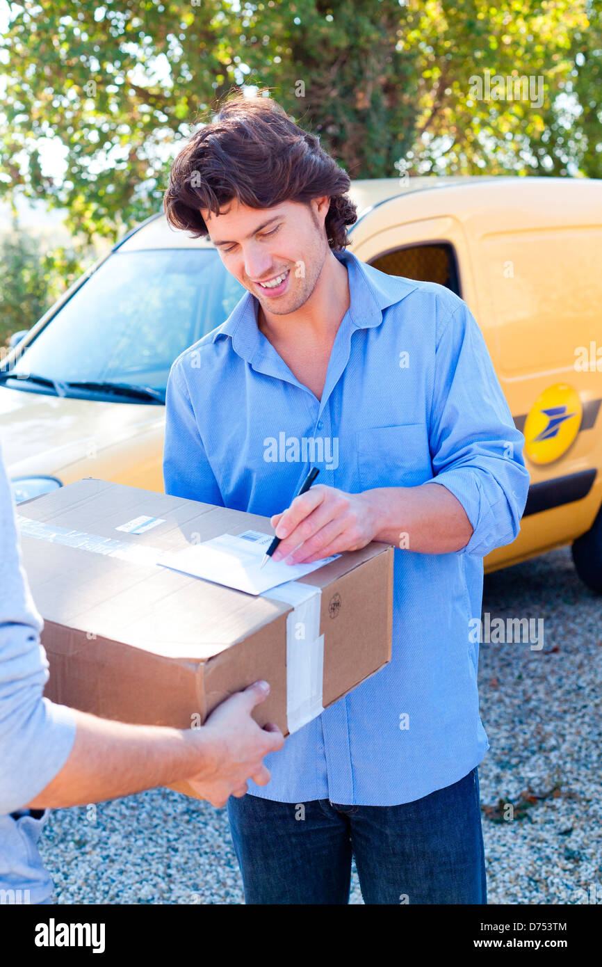 Man receiving package Stock Photo - Alamy
