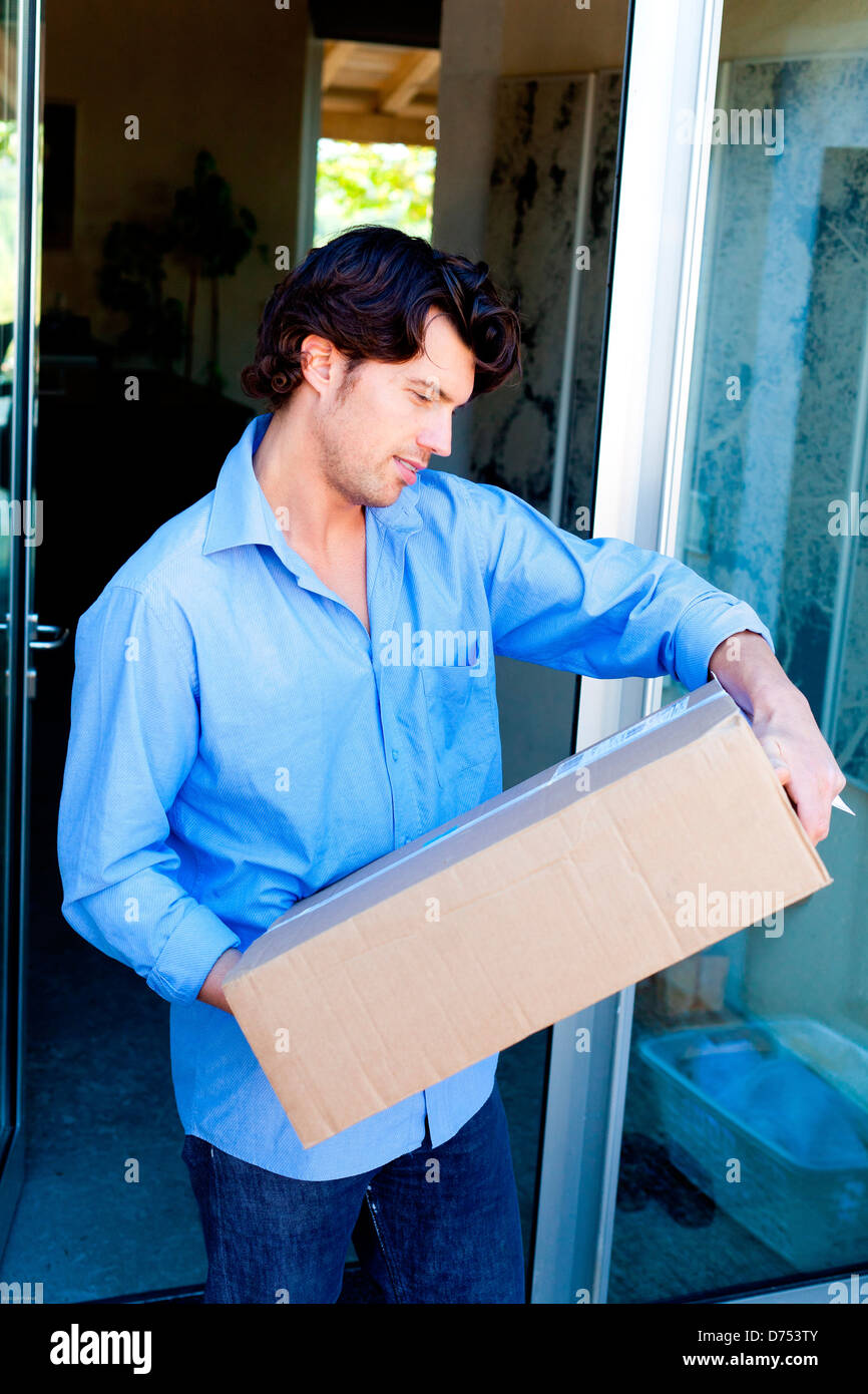 Man receiving package Stock Photo - Alamy
