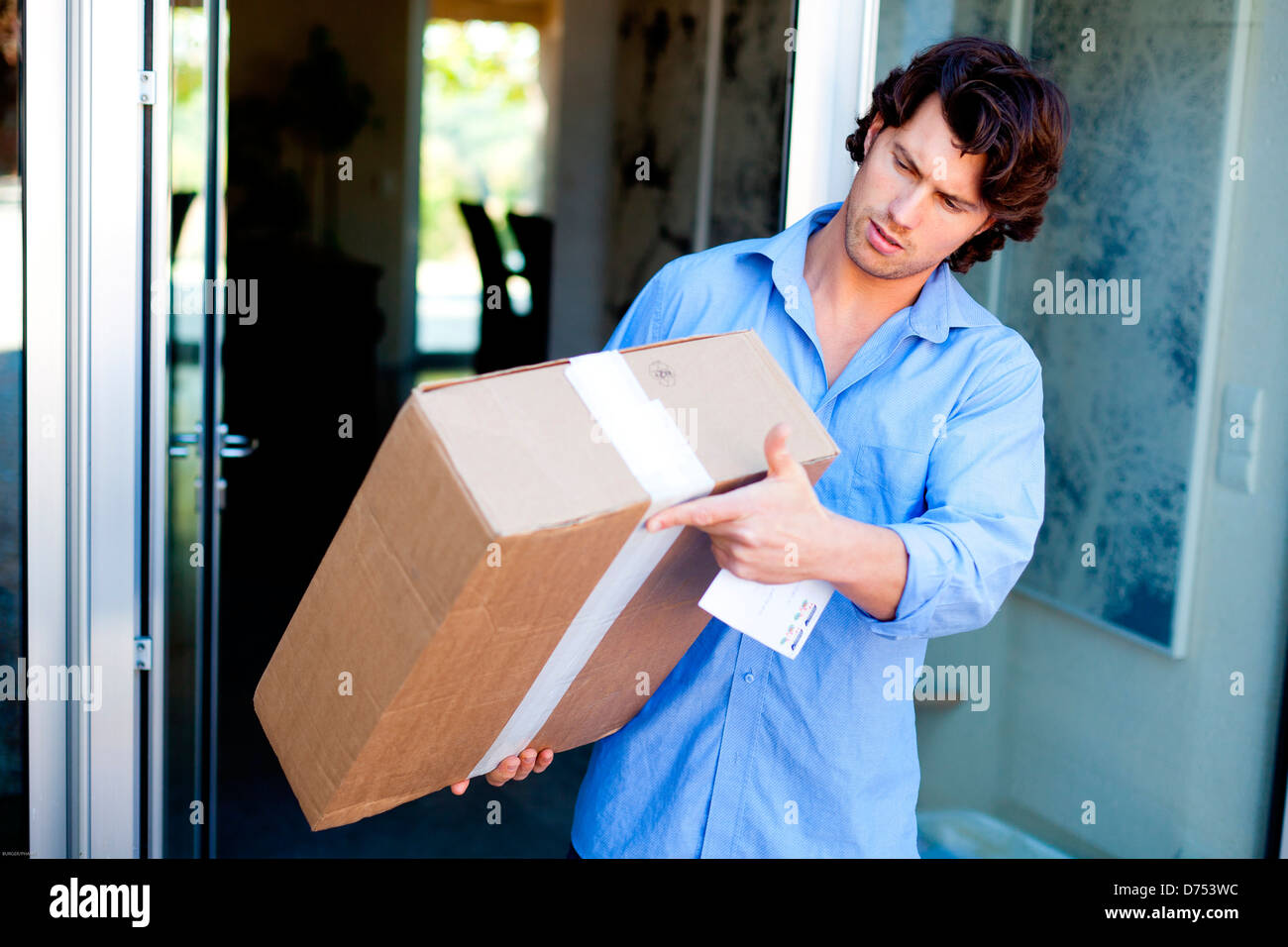 Man receiving package Stock Photo - Alamy