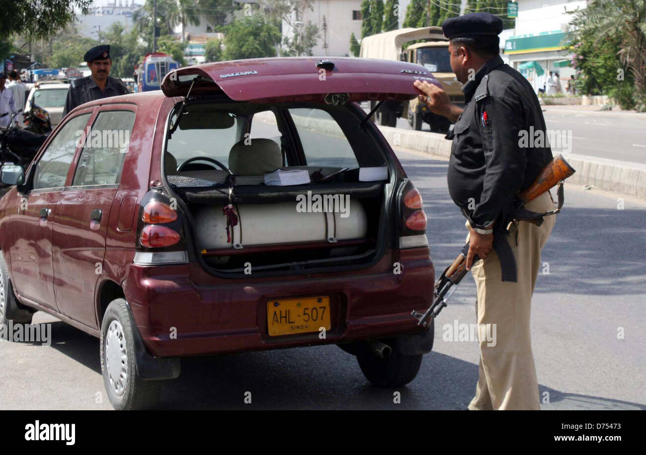 Police official busy in search vehicle during snap checking as the ...