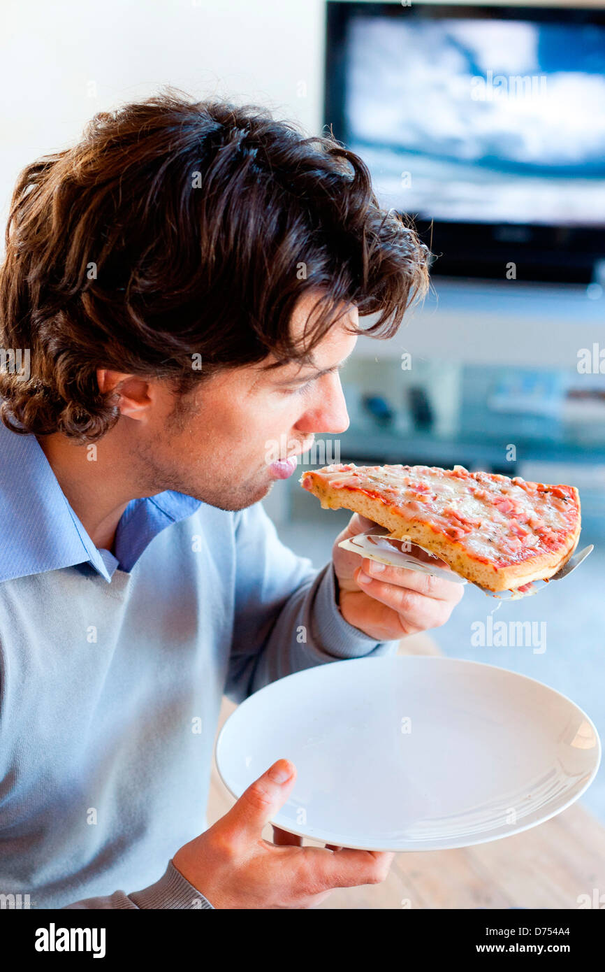 Man eating pizza Stock Photo - Alamy