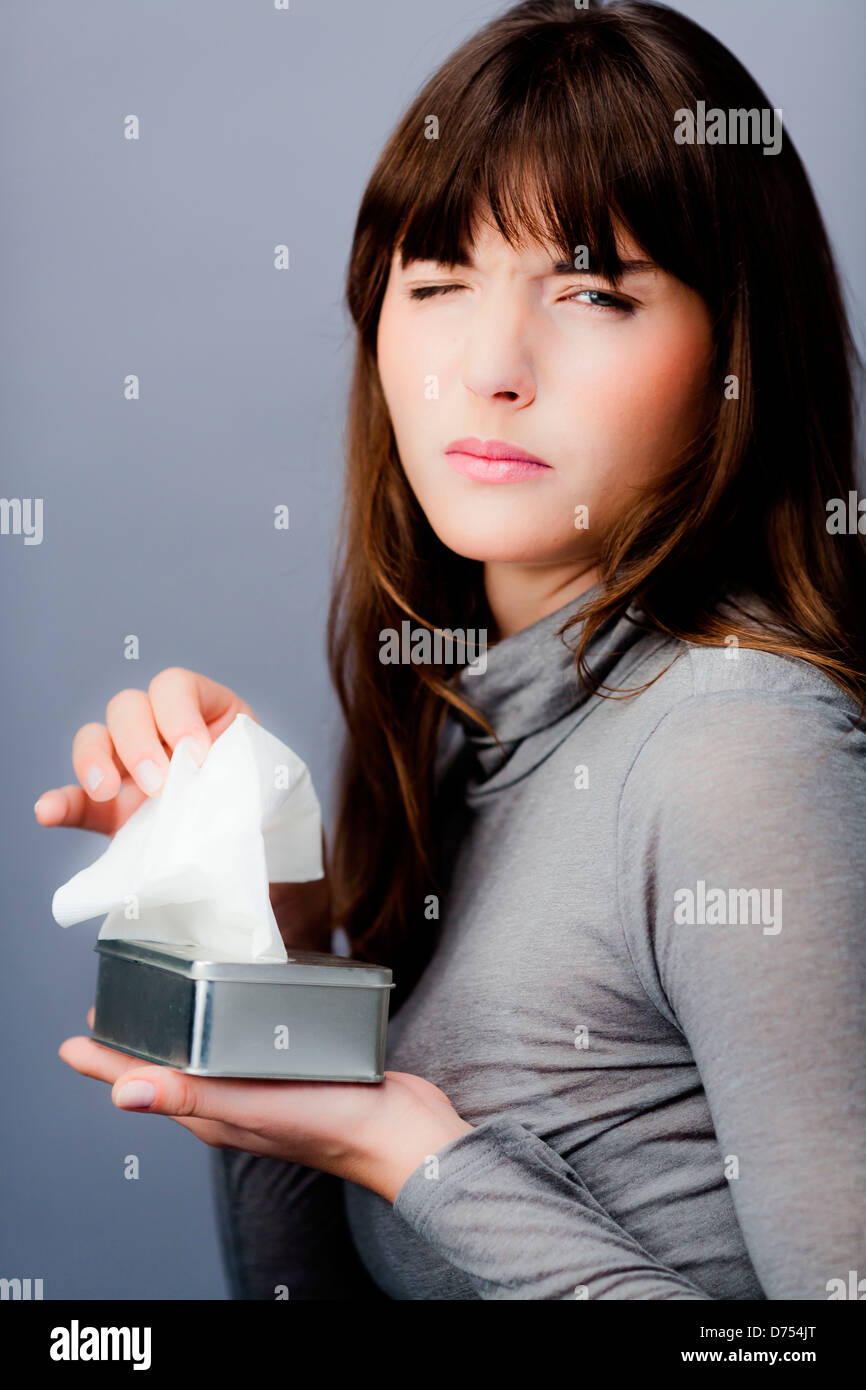woman with a cold using tissue Stock Photo - Alamy