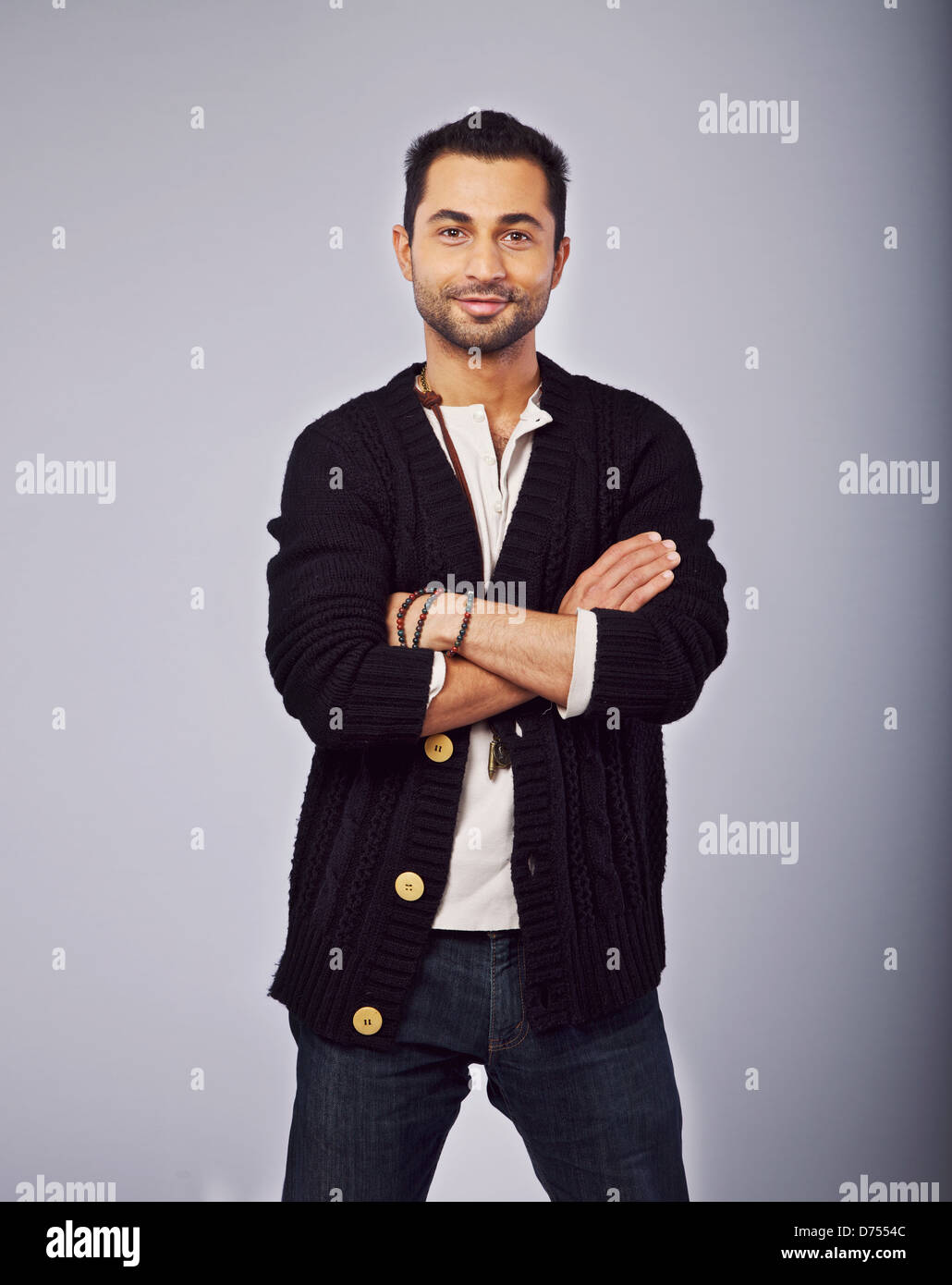 Portrait of a smiling fashionable guy standing in a studio Stock Photo ...