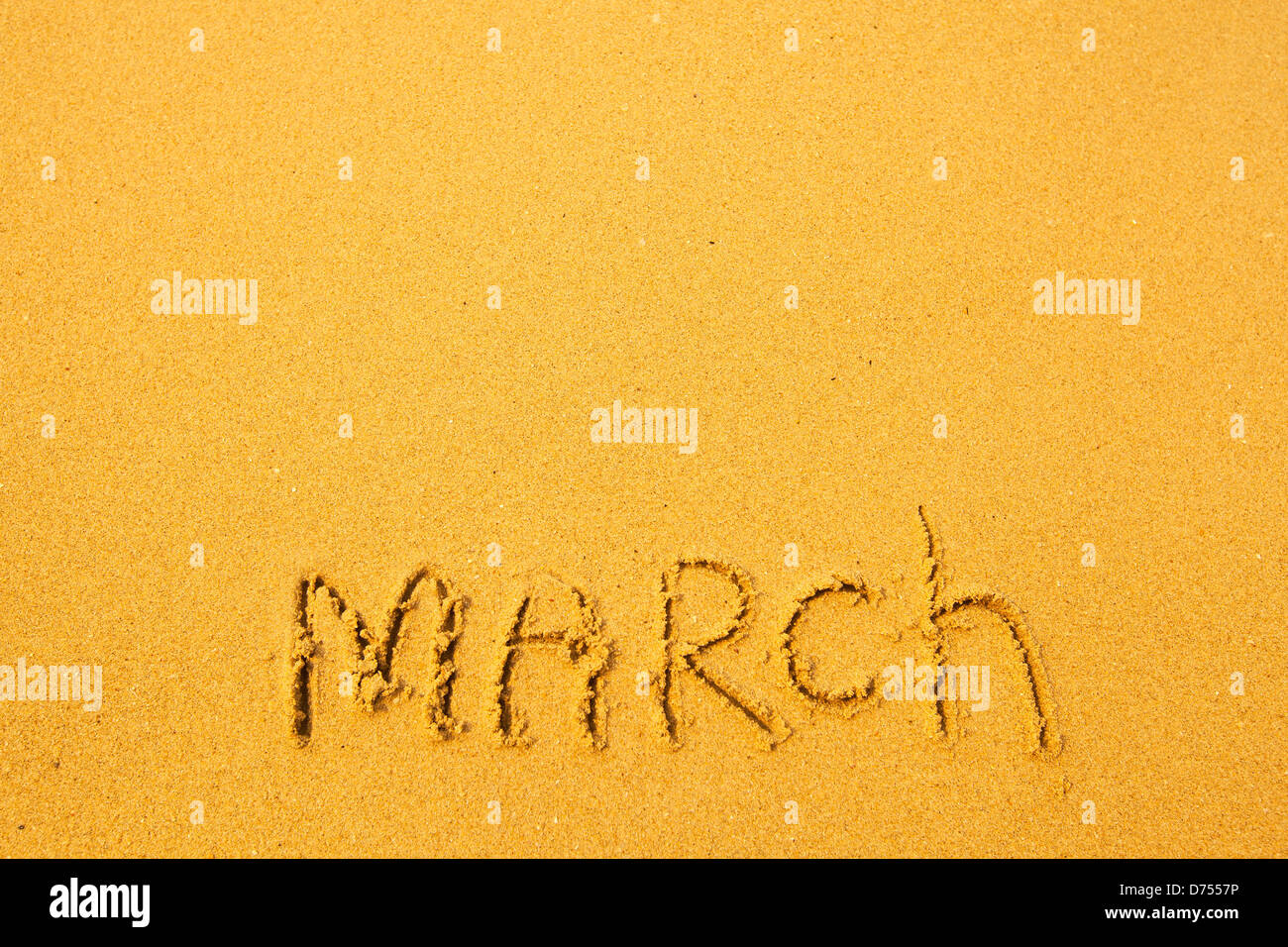 March - written in sand on beach texture (for background Stock Photo ...