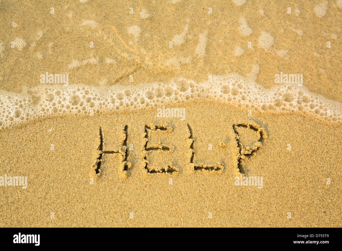 HELP - written in sand on beach texture - soft wave of the sea Stock ...