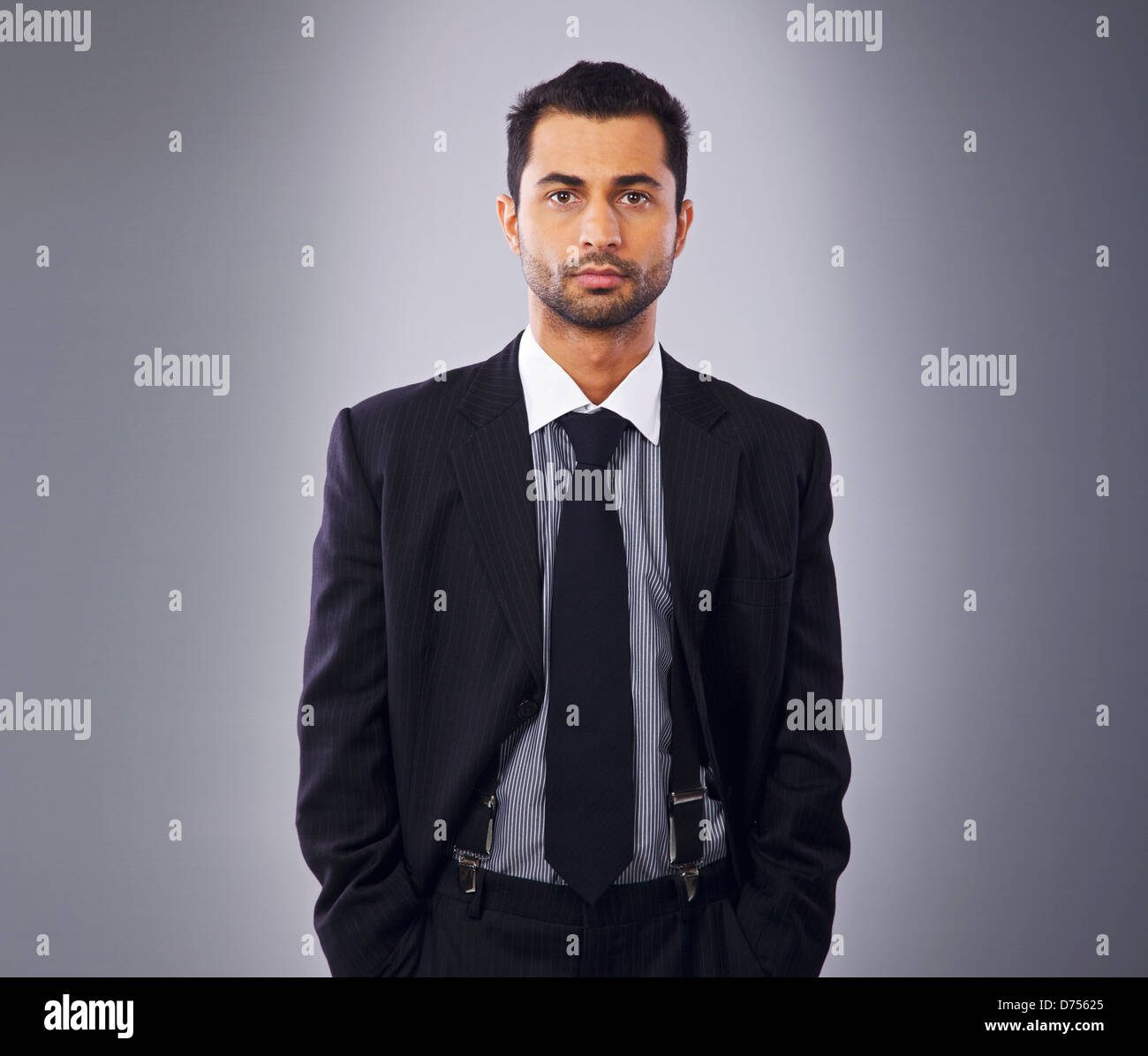 Handsome young executive in business suit standing in a studio Stock ...