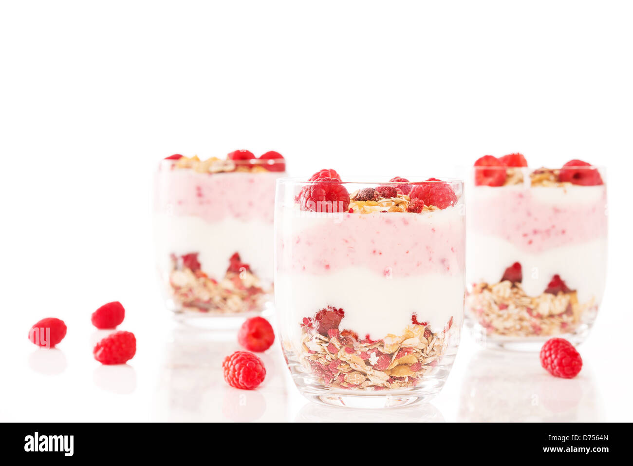 muesli yoghurt dessert with raspberries on white background Stock Photo ...