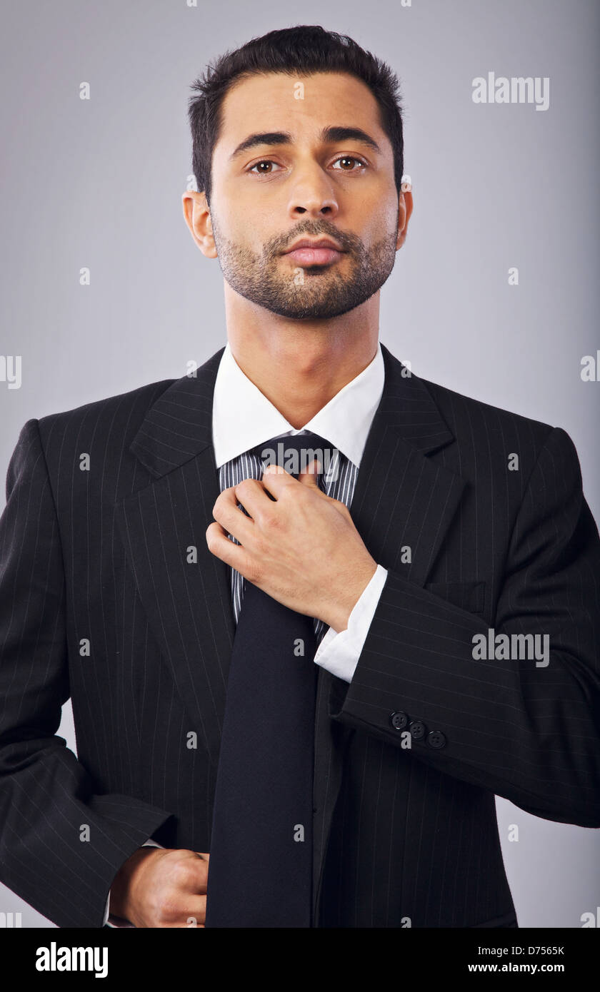 Portrait of a confident young businessman fixing his necktie Stock ...