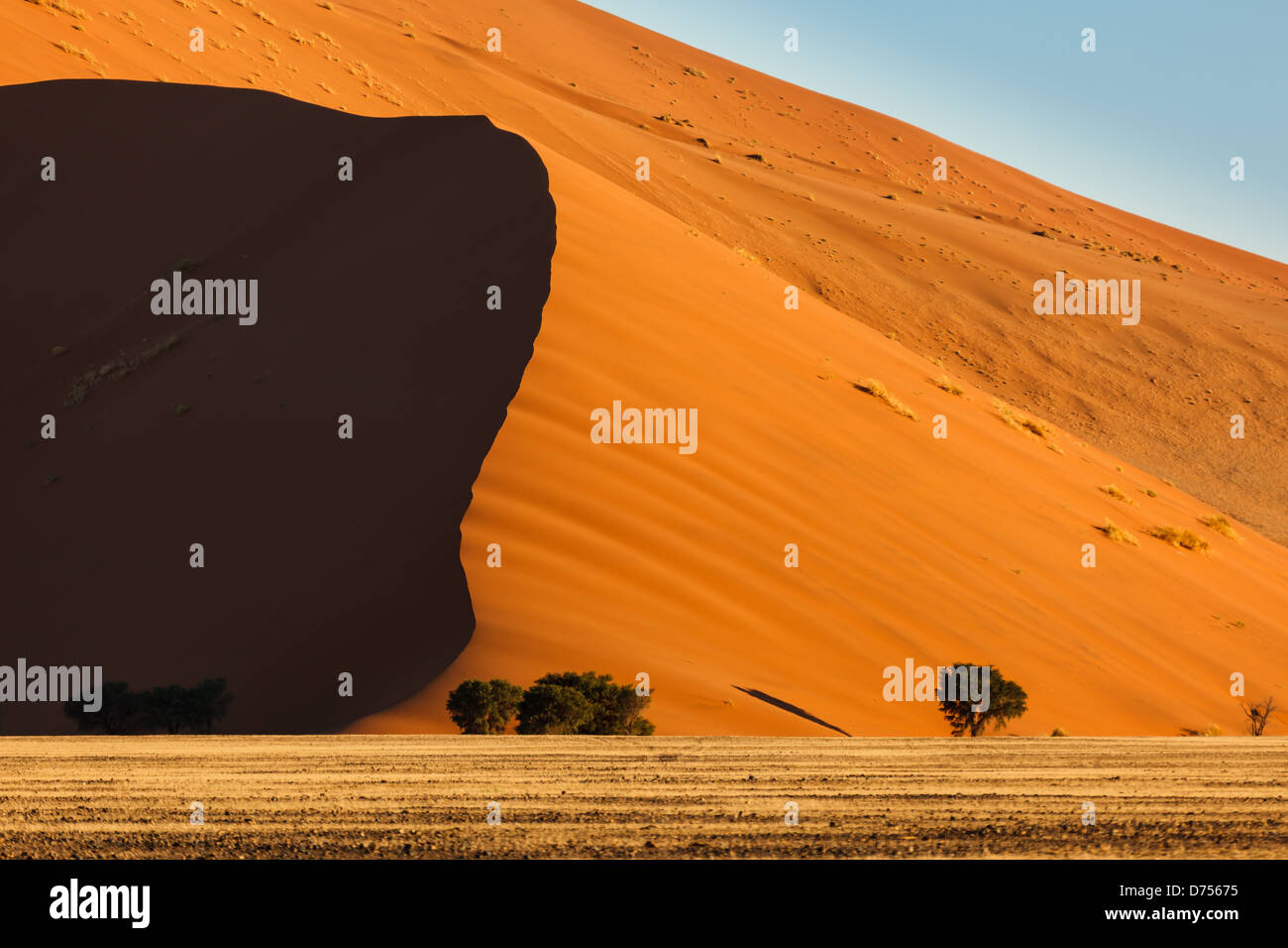 Base of red Namibian desert dunes left side in deep shadow Stock Photo ...