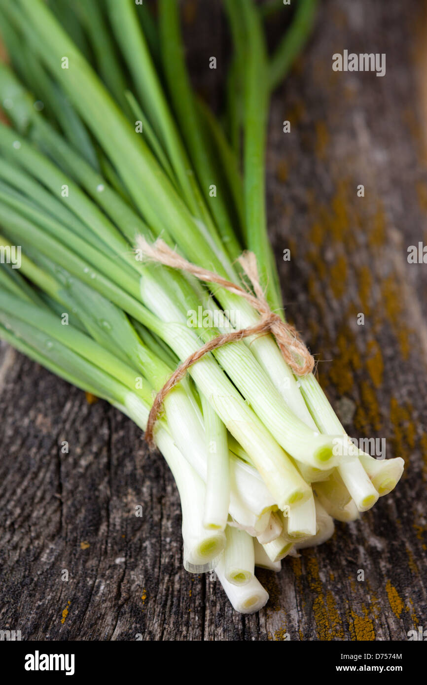 fresh green onions on the old board, closeup food Stock Photo - Alamy