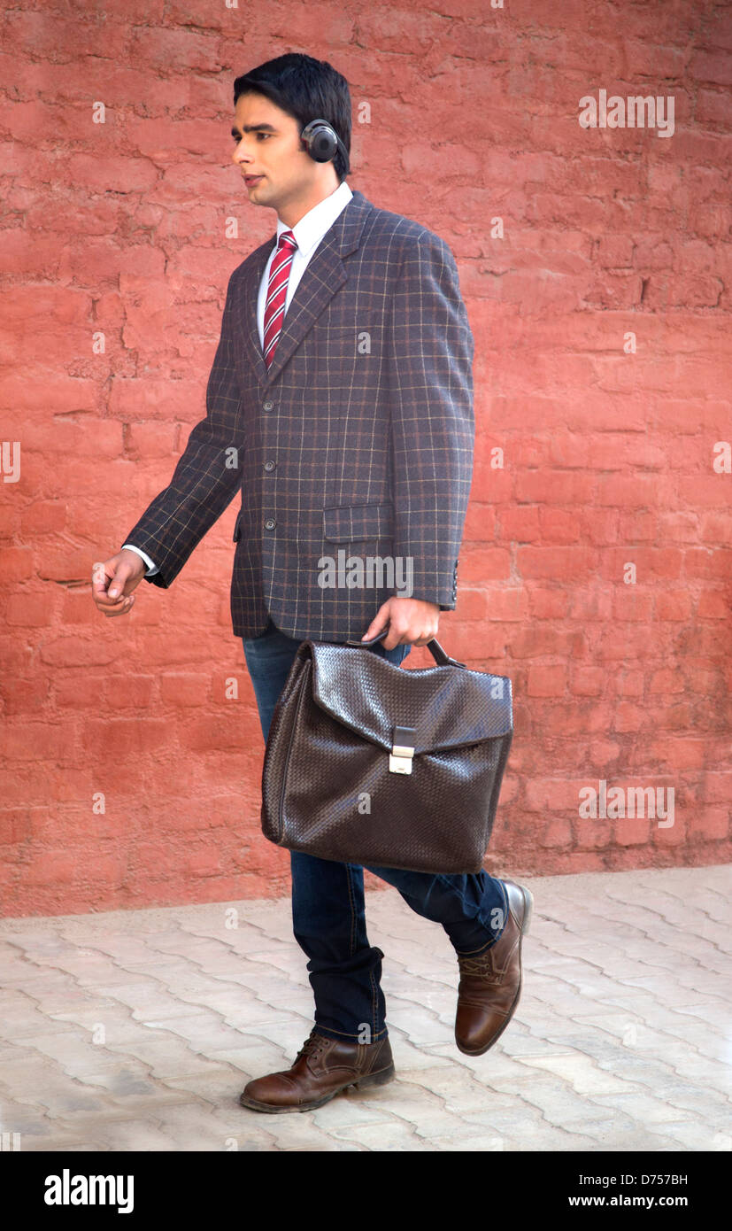 Businessman carrying briefcase on a street Stock Photo - Alamy