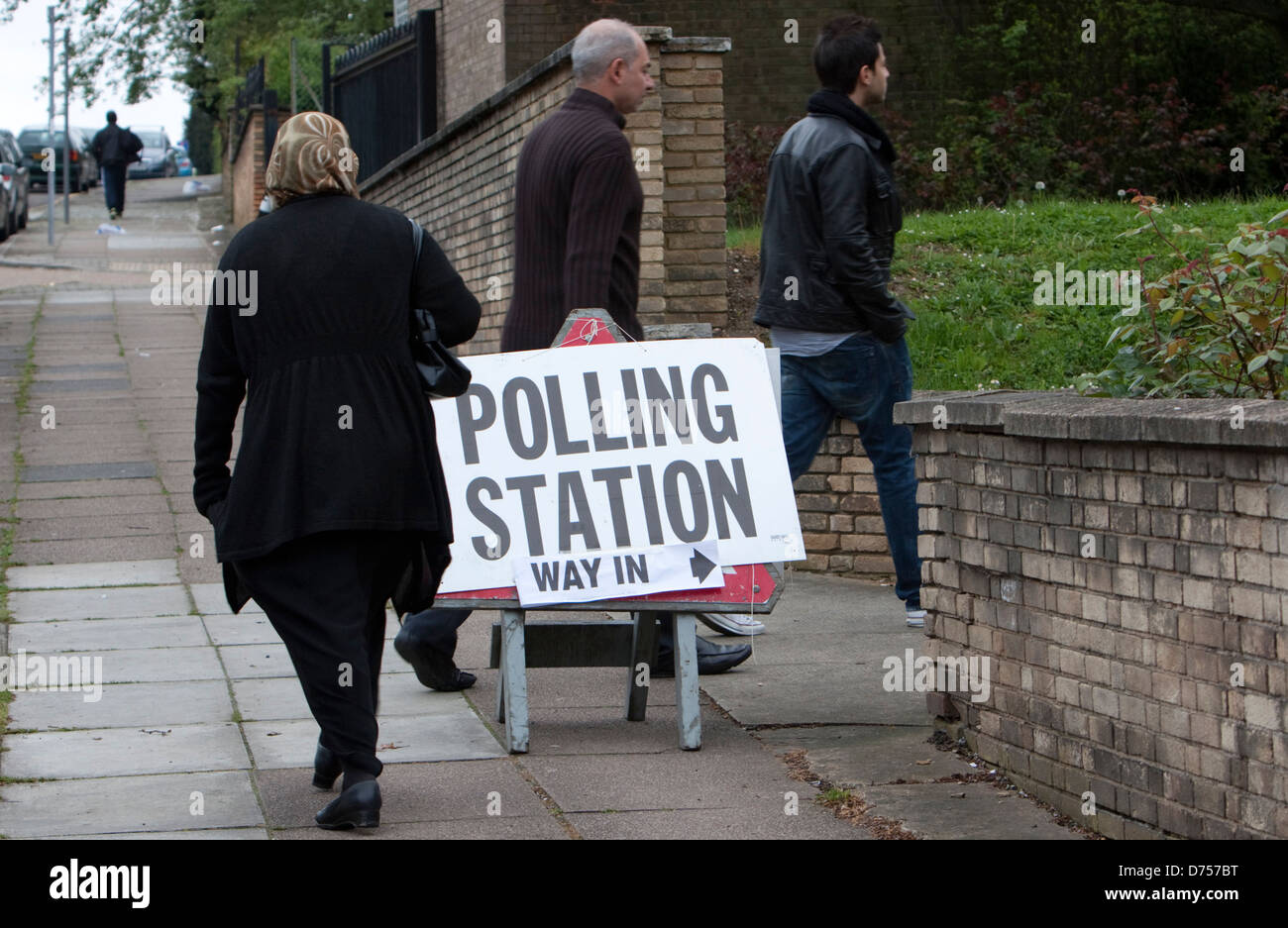 polling station signs with people coming and going, in north west ...