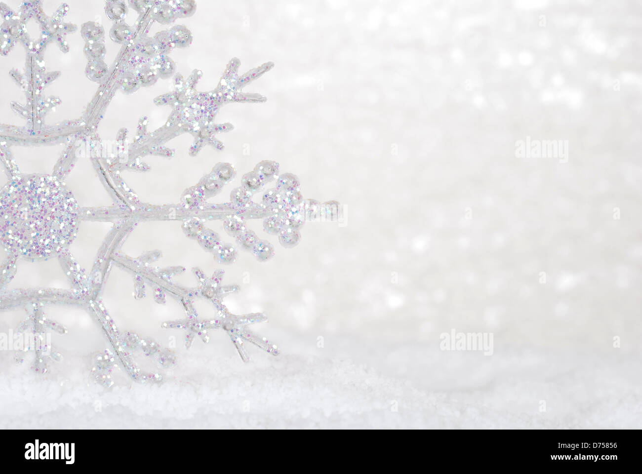 Glitter Snowflake in snow Stock Photo - Alamy