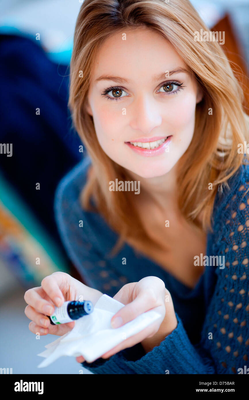 woman applying essential oil on a tissue Stock Photo - Alamy