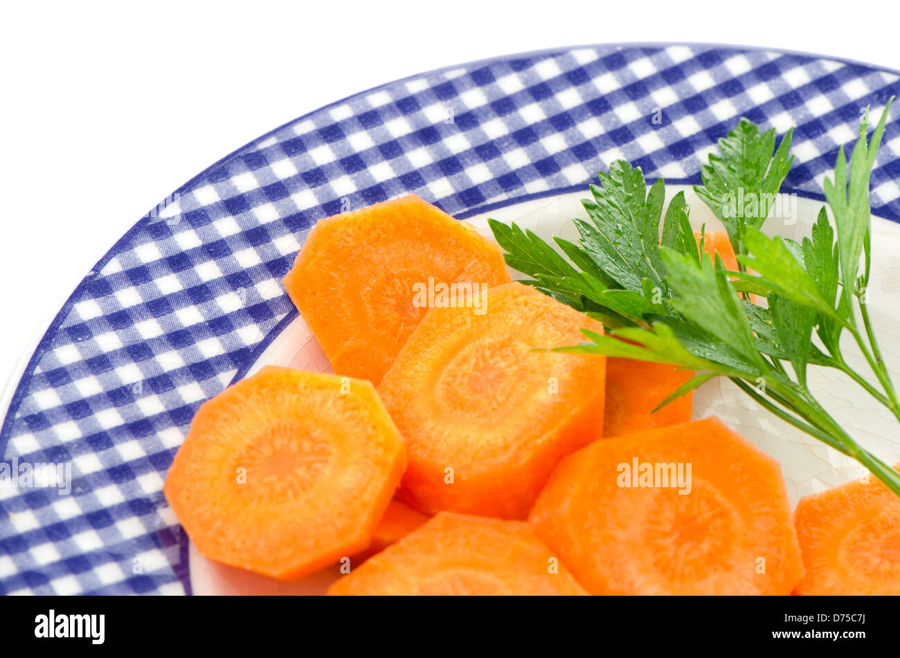 Sliced carrots in a white plate closeup isolated on white background ...