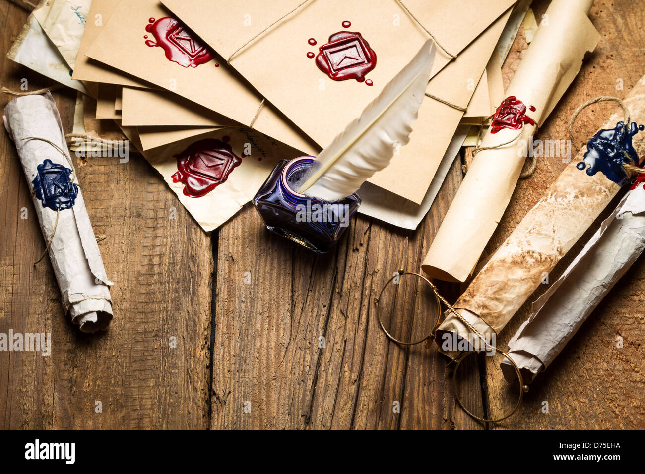 Ancient scrolls and old envelope with blue inkwell Stock Photo - Alamy