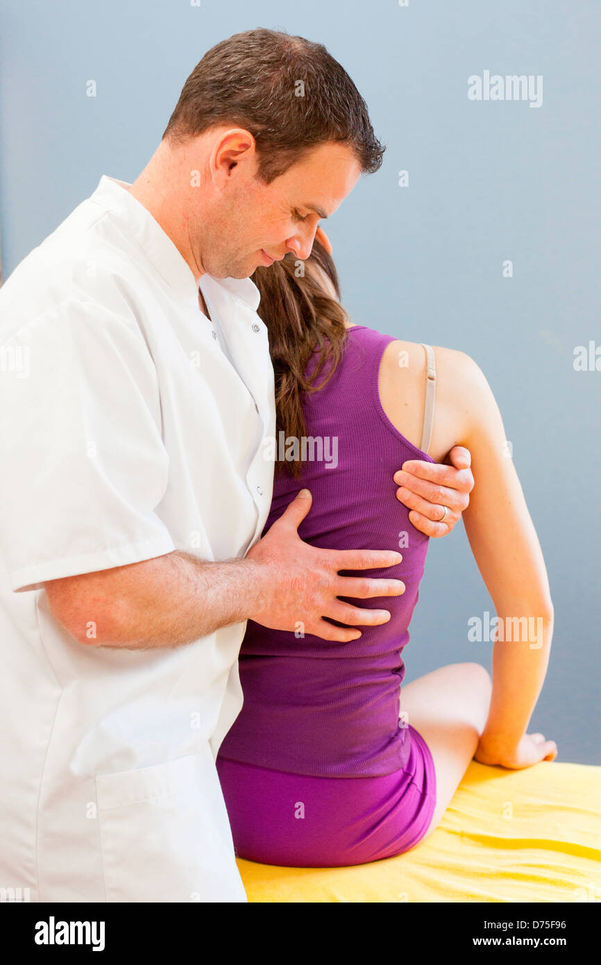 Structural osteopathy session on a woman with low back pain Stock Photo ...