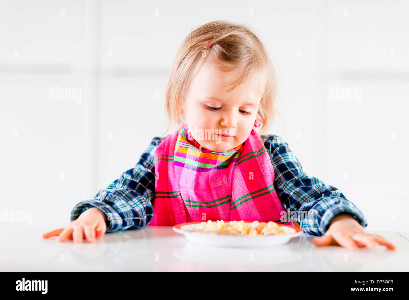 24 month old baby girl eating alone. Independence training Stock Photo ...