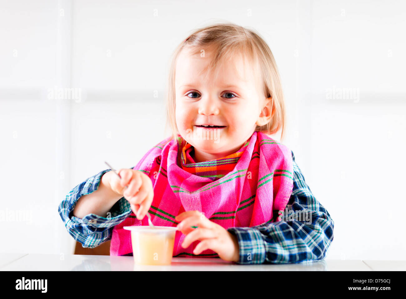 24 month old baby girl eating alone. Independence training Stock Photo ...